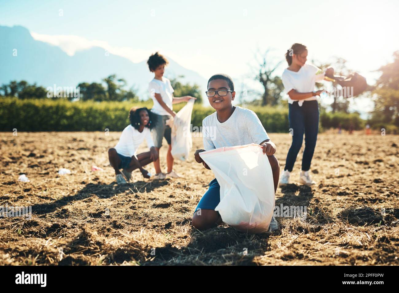 First we play then we pack it away. a group of teenagers picking up ...