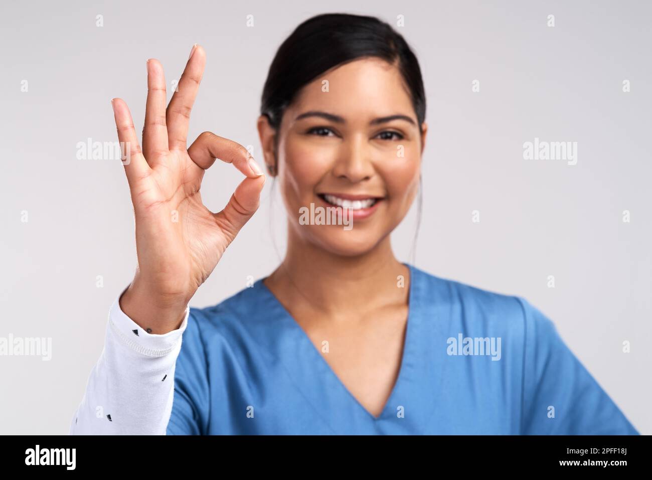 Home is where the scalpel is. Portrait of a young doctor showing the ok ...
