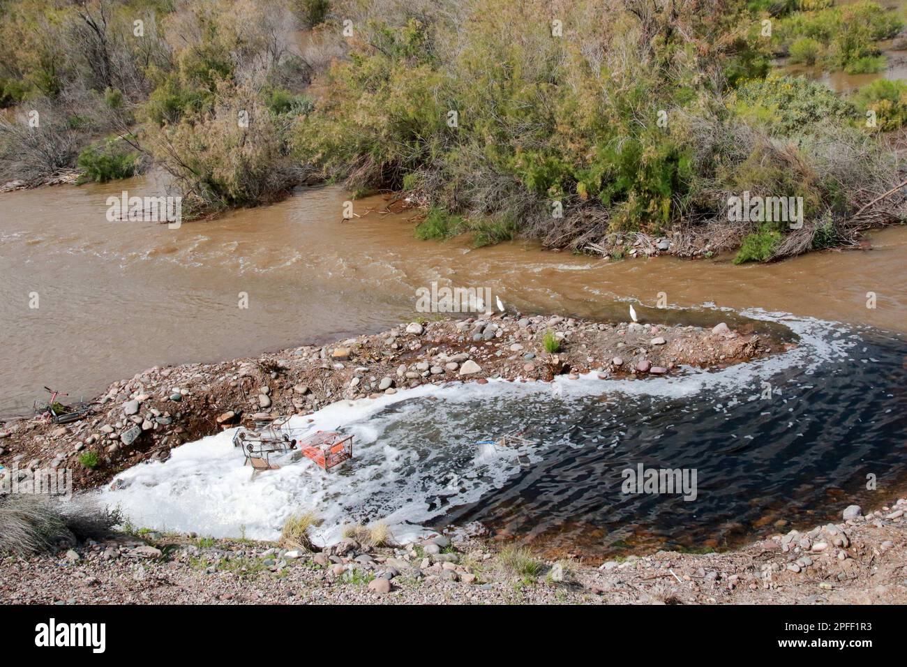 Water from storm drains gets released into the Salt River in Mesa, Arizona USA on March 16, 2023 ...