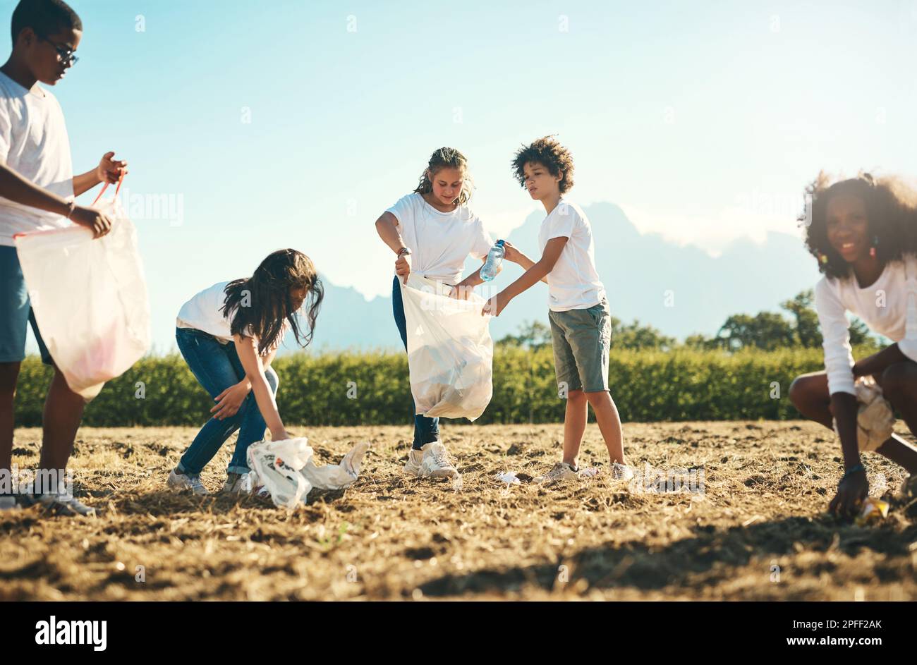 African child picking up litter hi-res stock photography and images - Alamy