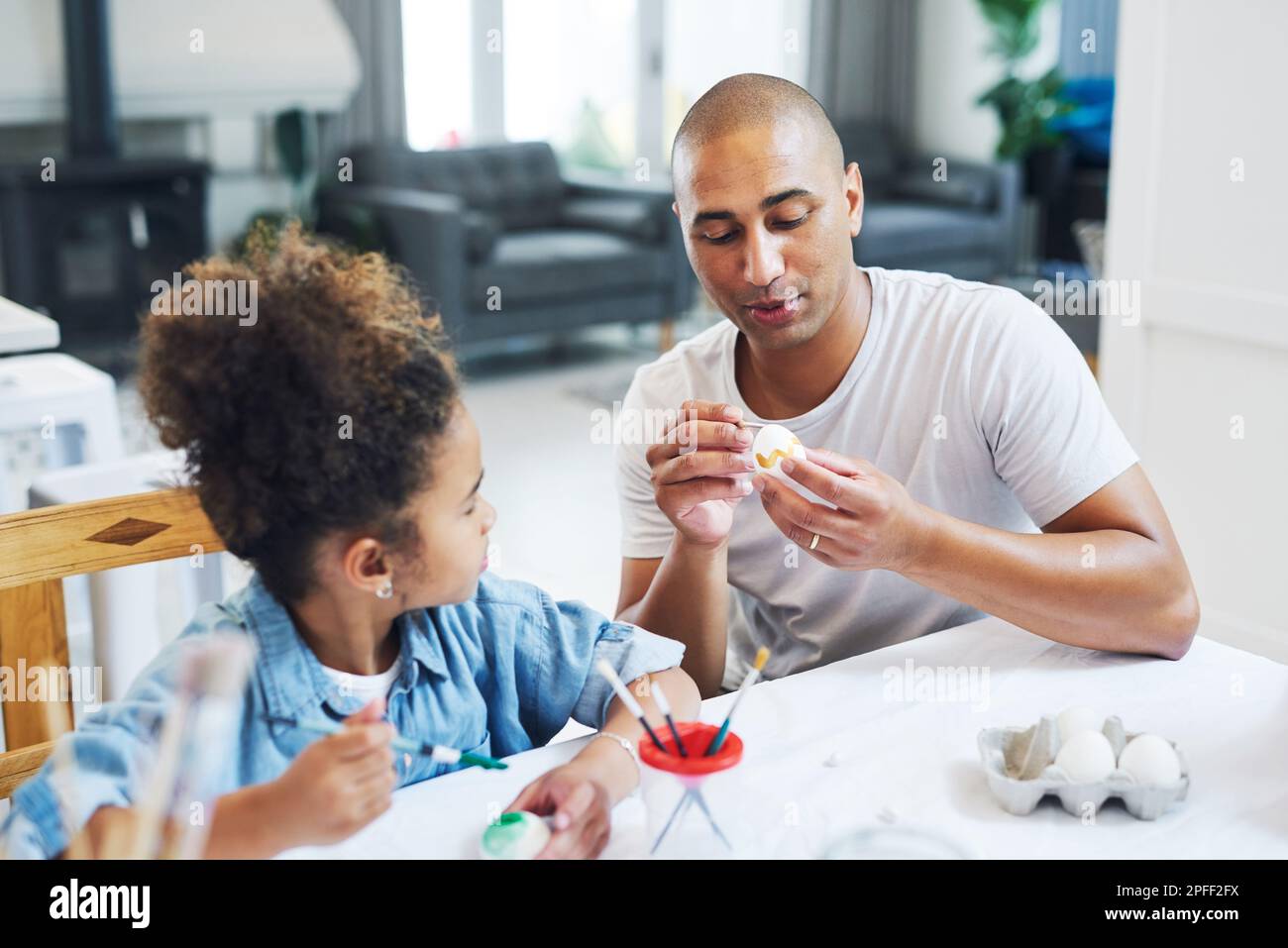 Behind every great daughter is a truly amazing dad. a man painting eggs ...