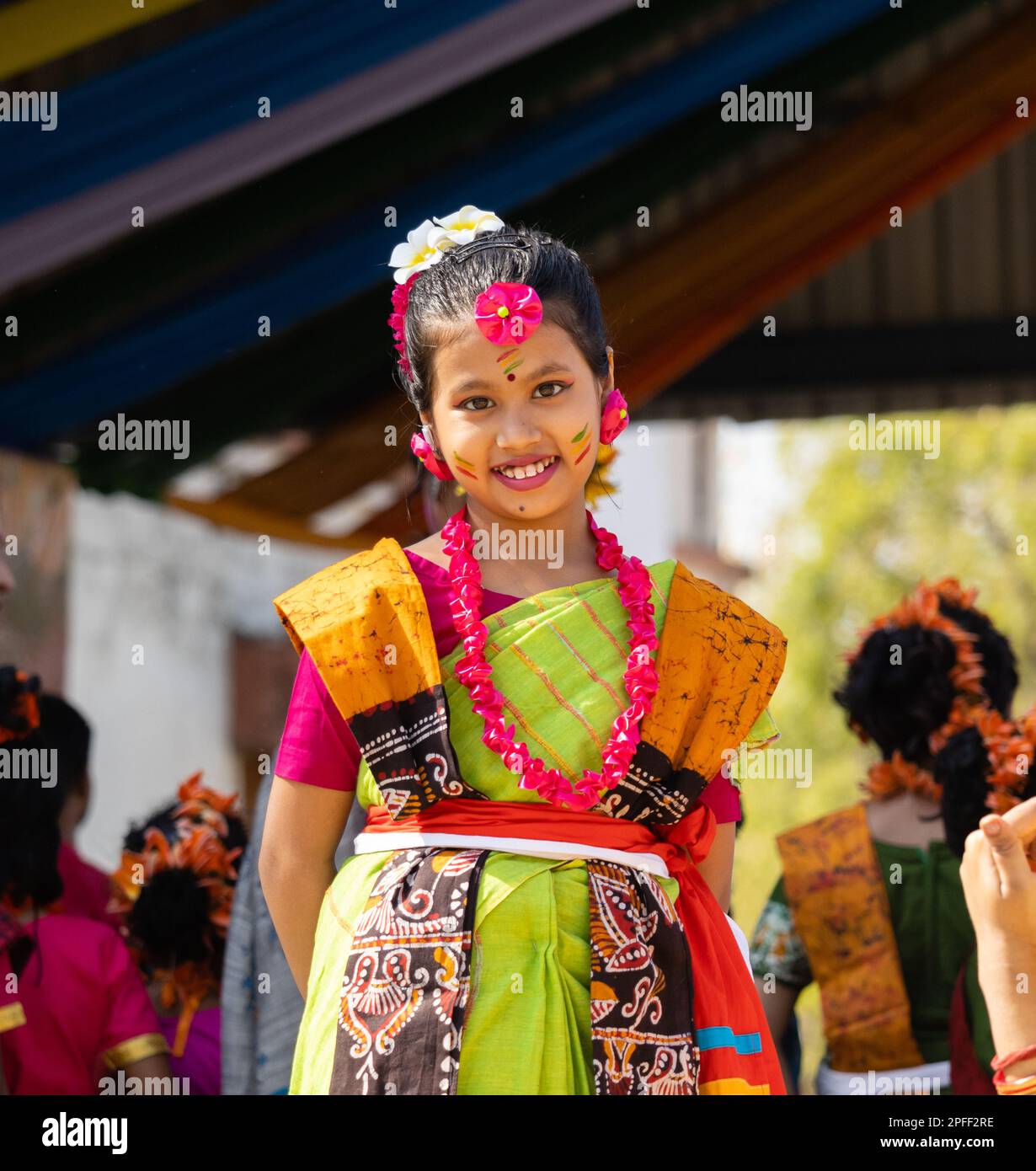 An Indian Bengli girl child with colorful face and tradition dress in ...