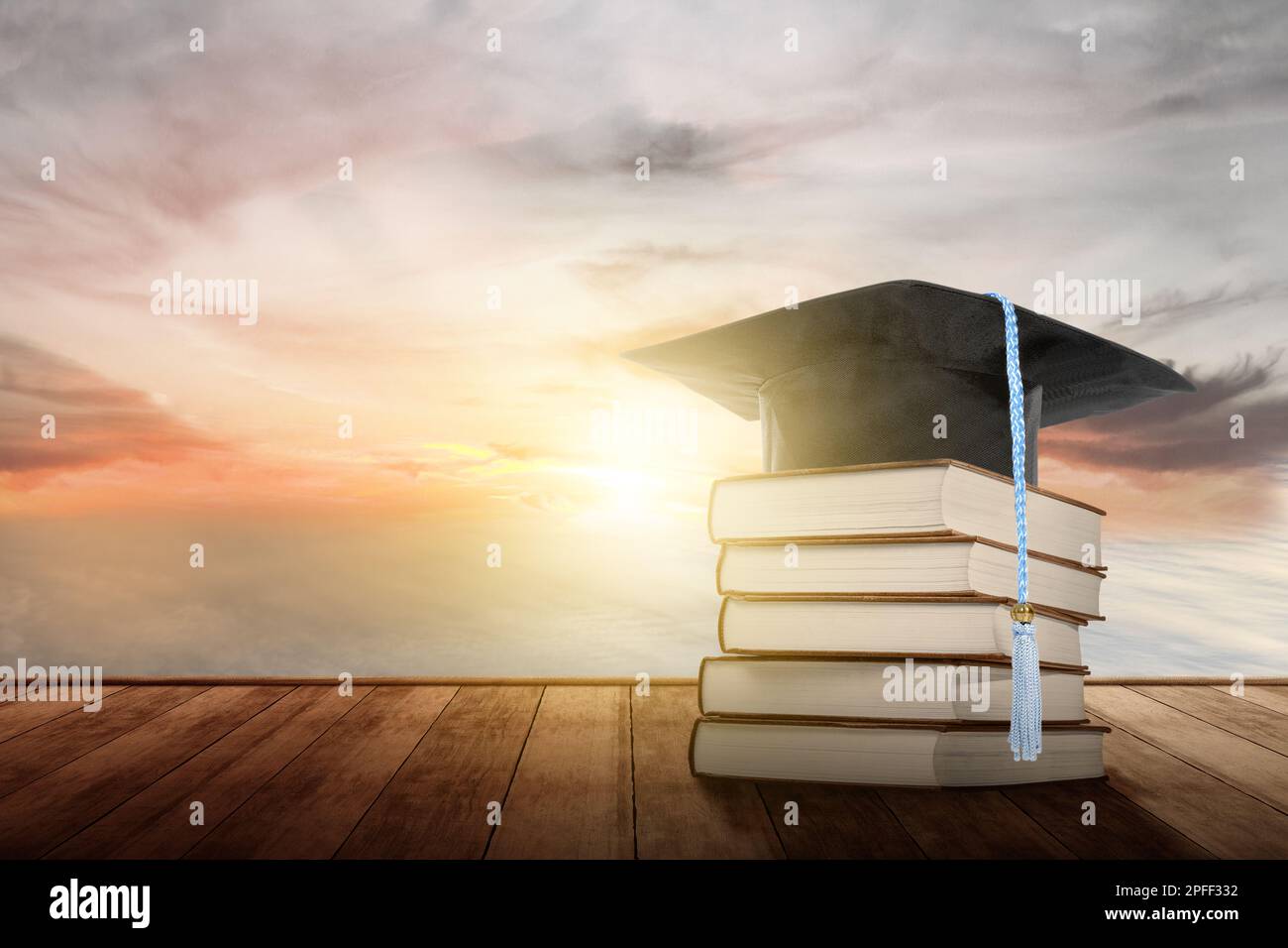 The pile of books and graduation caps with the sunset scene background ...