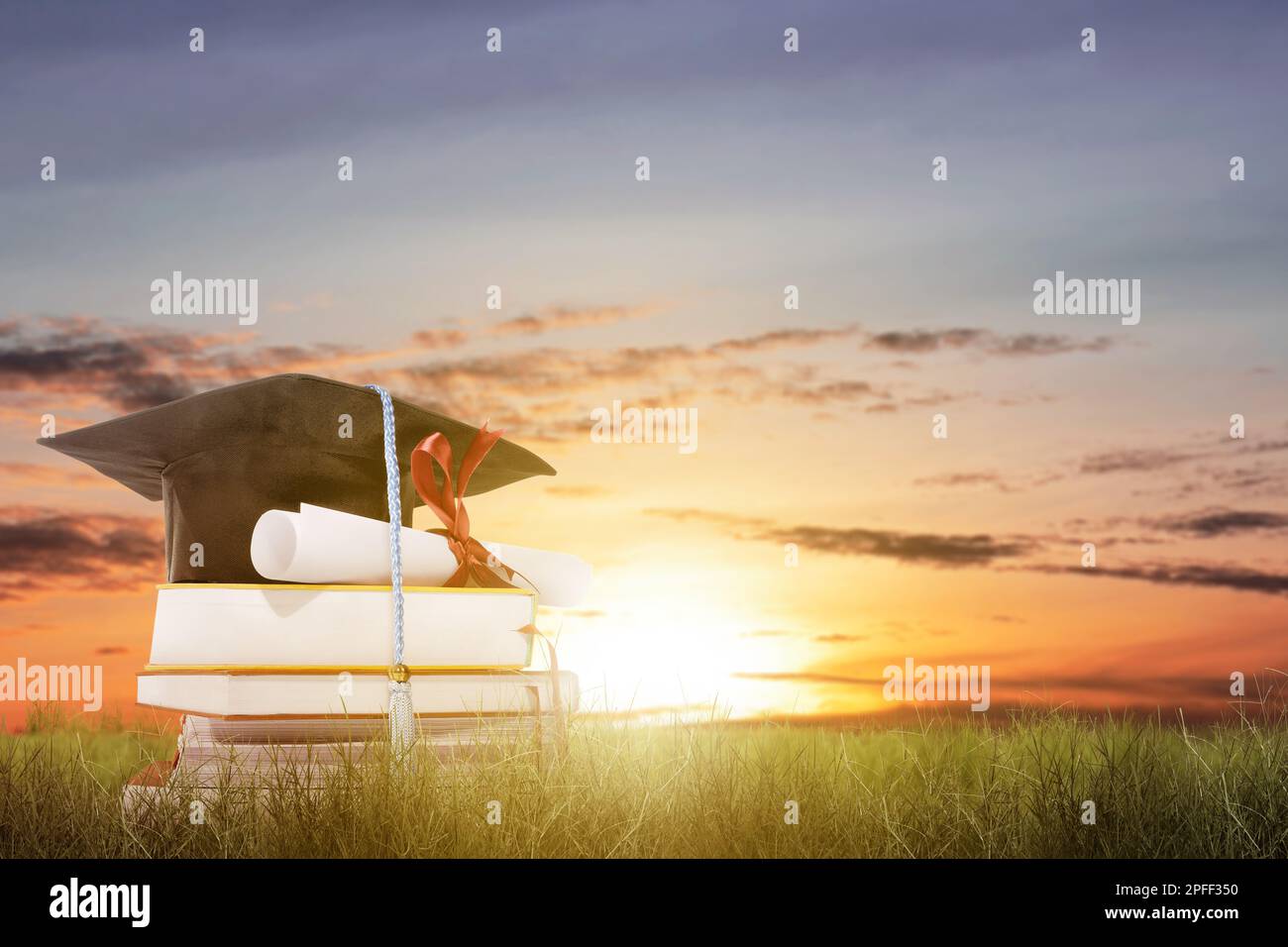 The pile of books and graduation scroll with graduation caps with the ...
