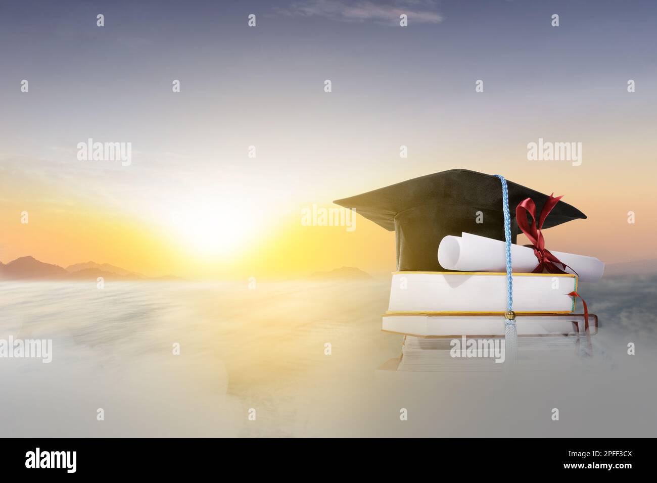 The pile of books and graduation scroll with graduation caps with the ...