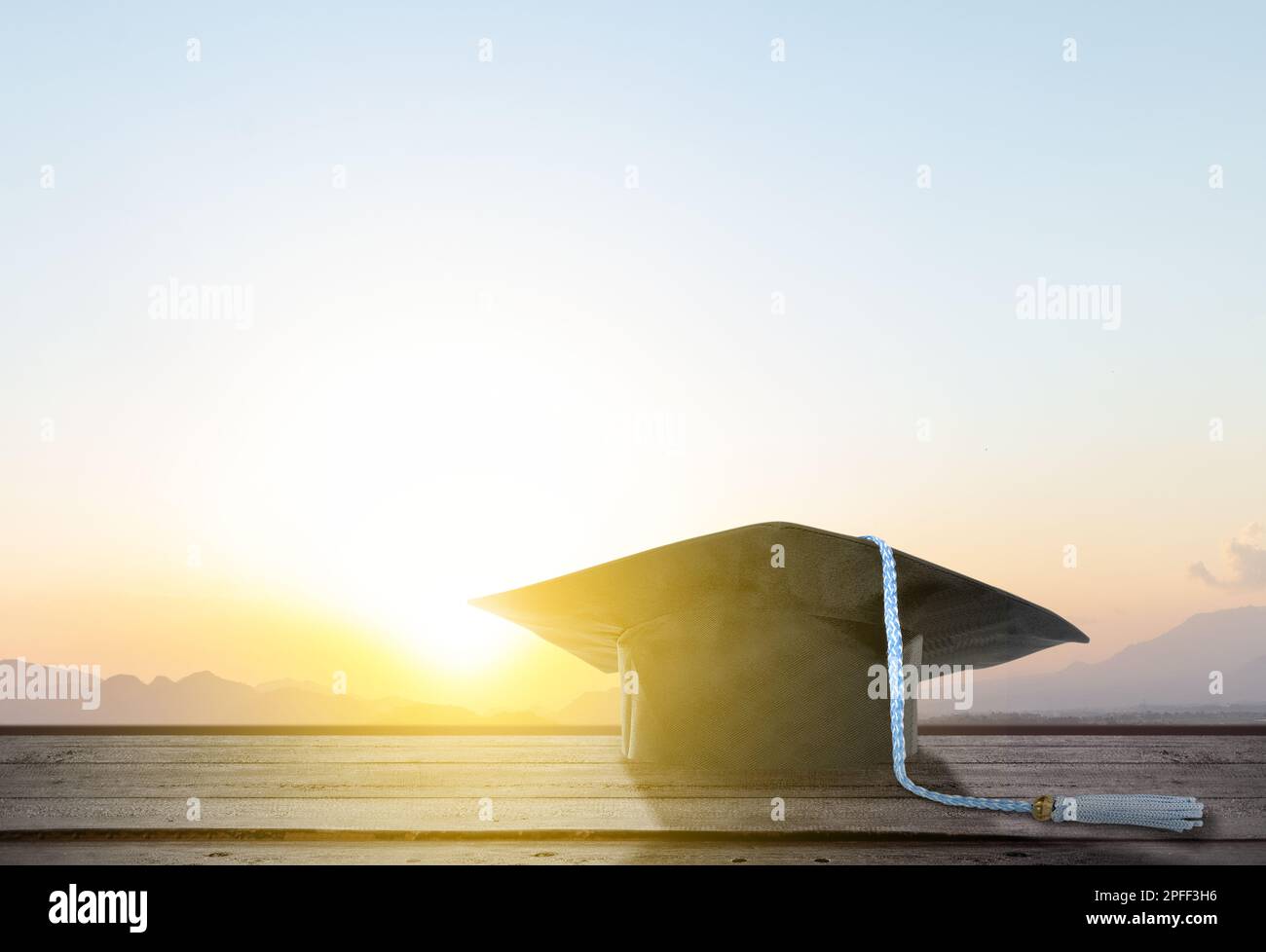 Graduation caps with the sunset scene background Stock Photo - Alamy