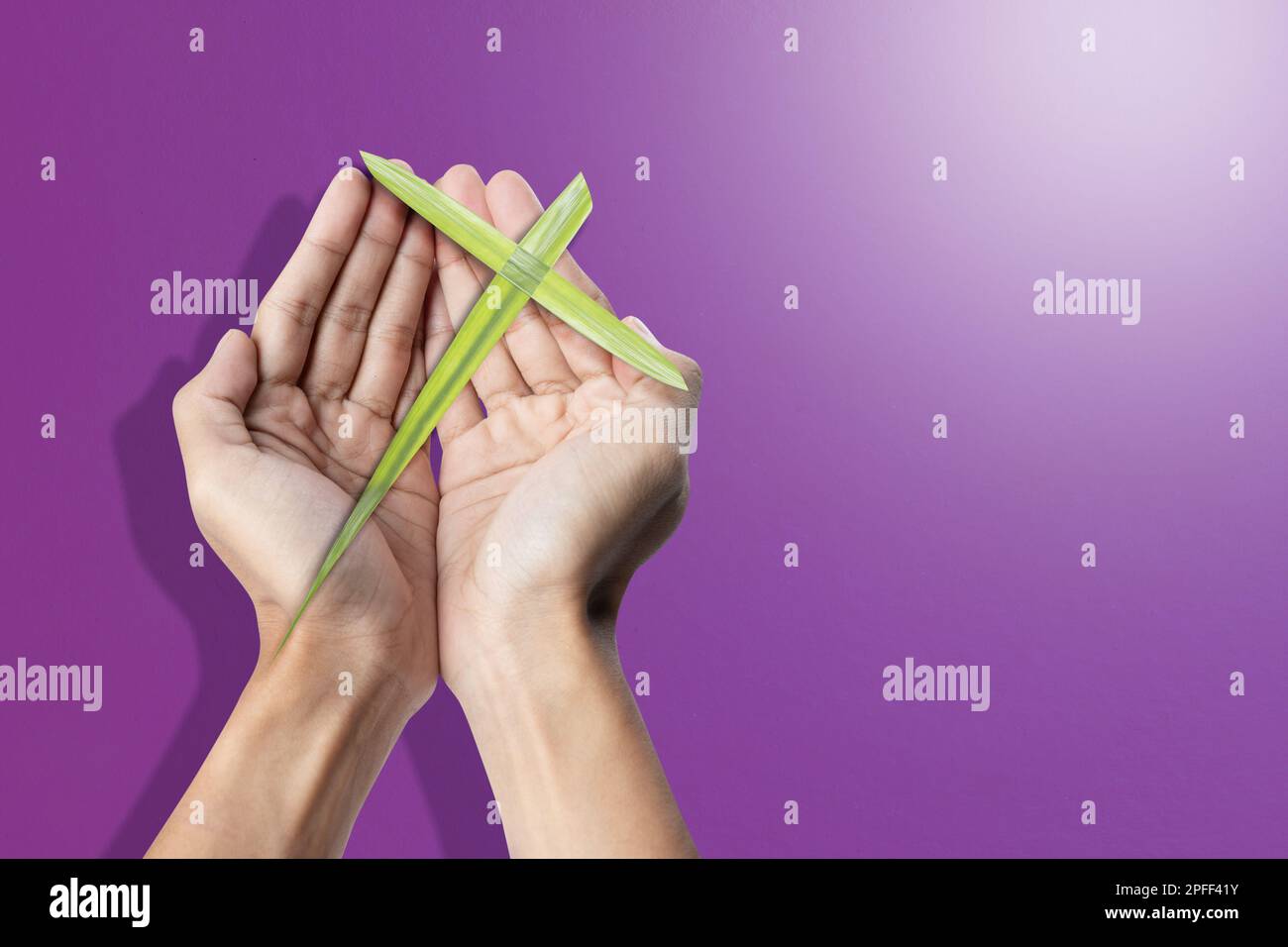Human hand holding palm leaf with a cross shape. Palm Sunday Concept ...