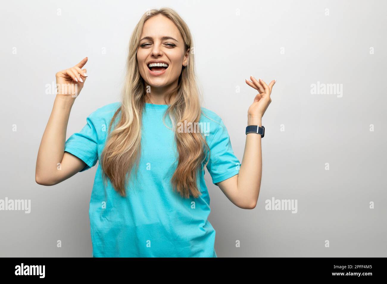 cheerful girl getting high on white studio background Stock Photo - Alamy