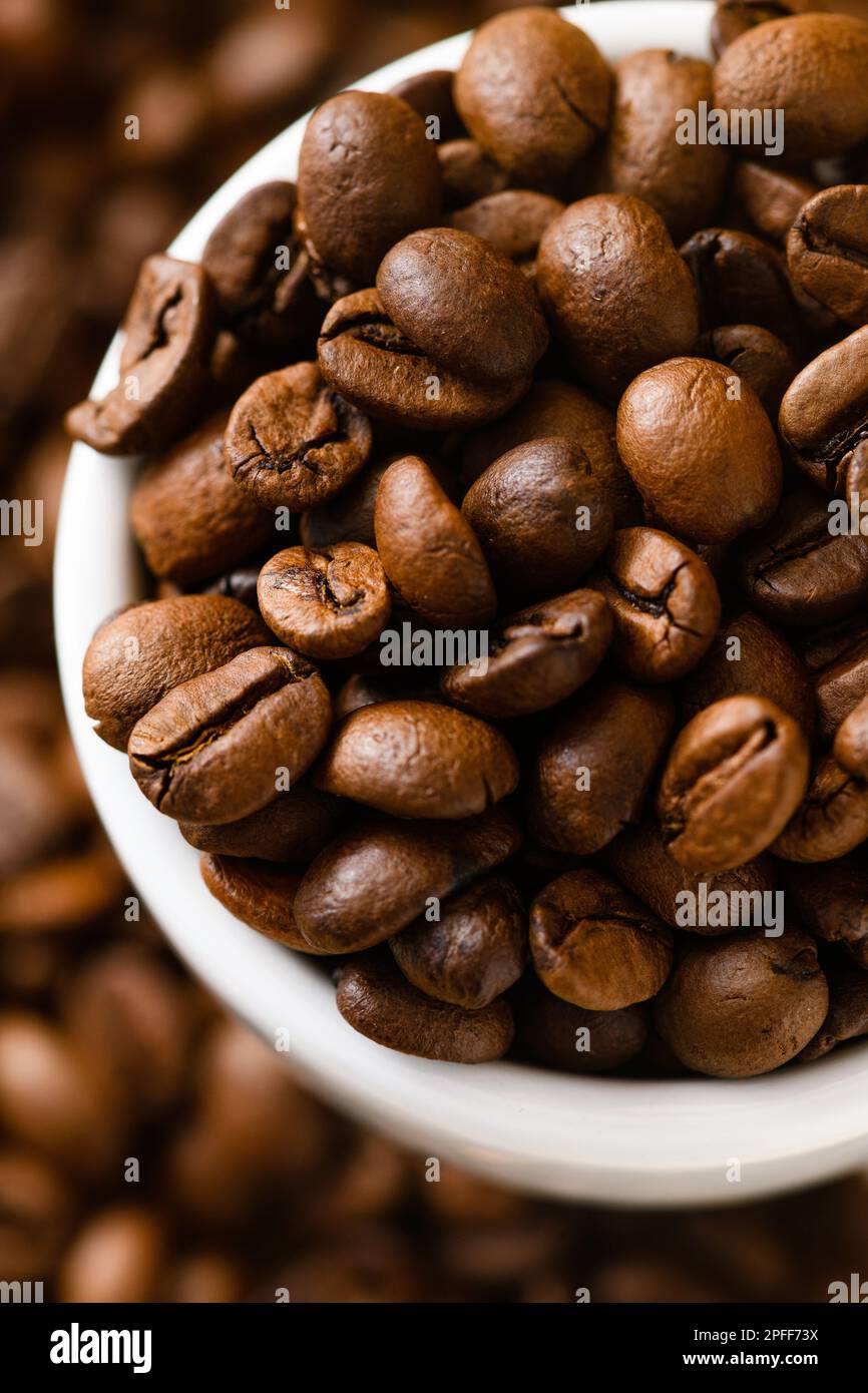 Coffee brown background with many beans and cup, top view, morning ...