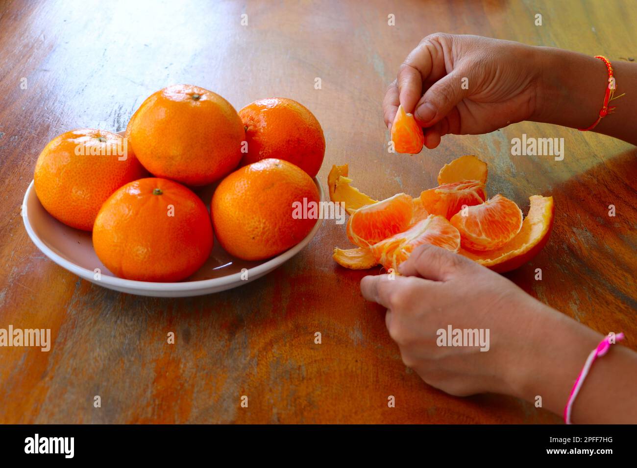 Hand peeling fresh orange fruit hi-res stock photography and images - Alamy