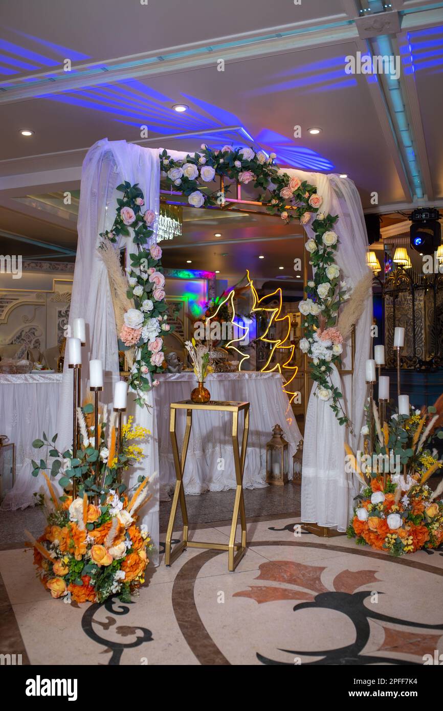 decorative arch with flowers for a wedding ceremony in a restaurant ...