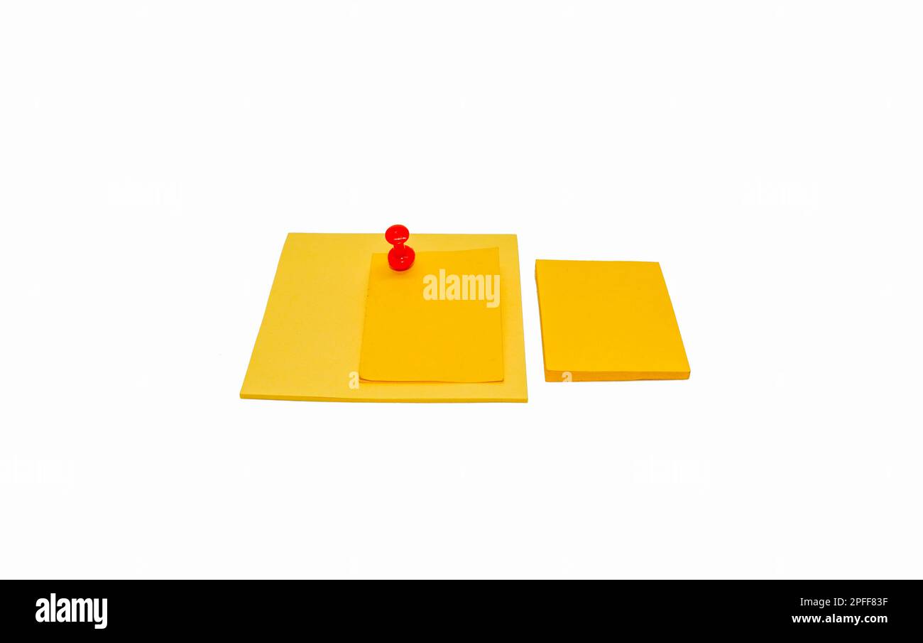 Yellow sticky notes and red pin needle isolated on white background ...
