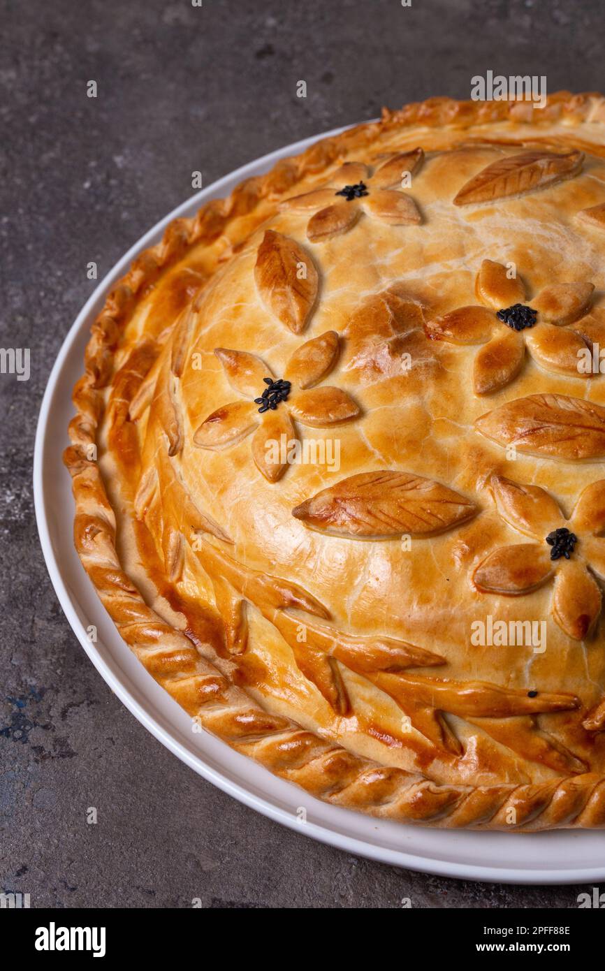 hot homemade chicken pie with filling. pie on the table Stock Photo - Alamy