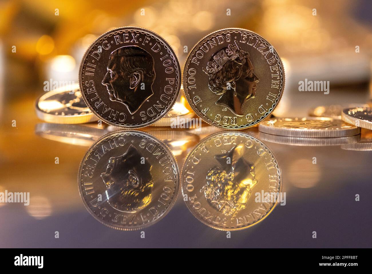 Munich, Germany. 16th Mar, 2023. Gold bars and gold coins in different ...