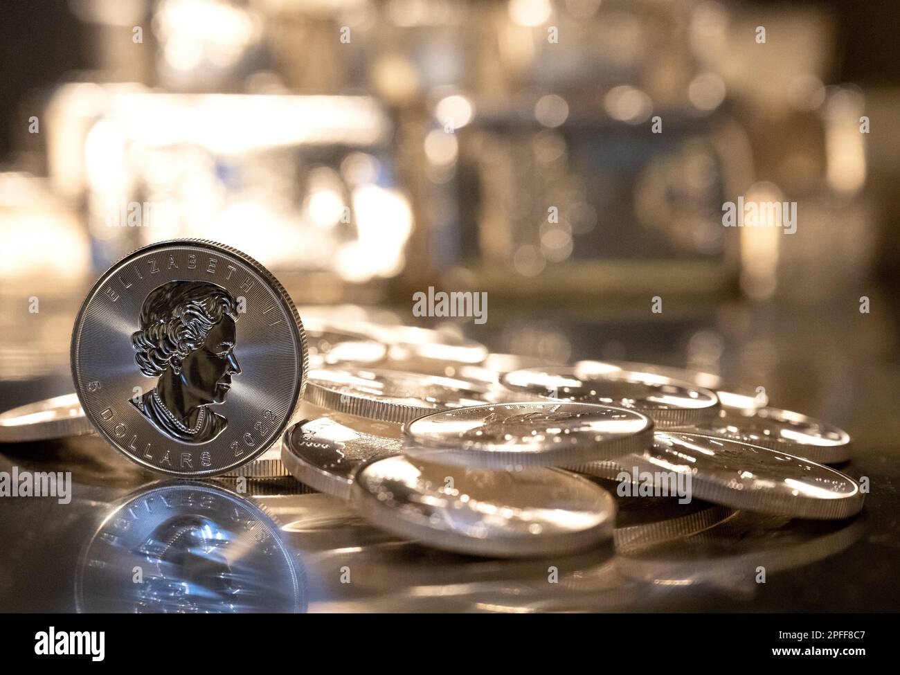 Munich, Germany. 16th Mar, 2023. Silver coins lie in a safe on a table ...