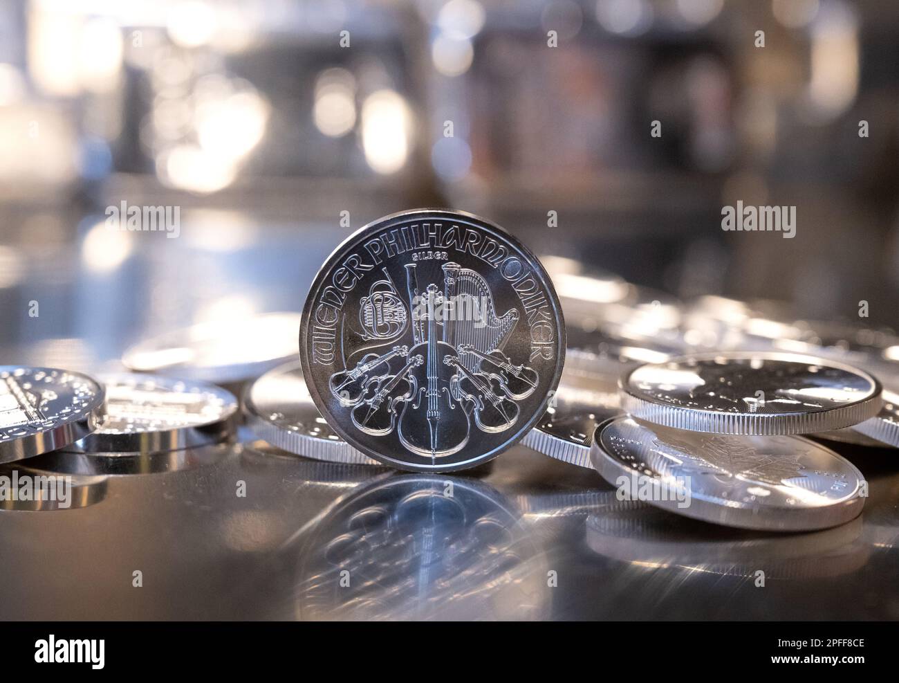 Munich, Germany. 16th Mar, 2023. Silver coins lie in a safe on a table ...