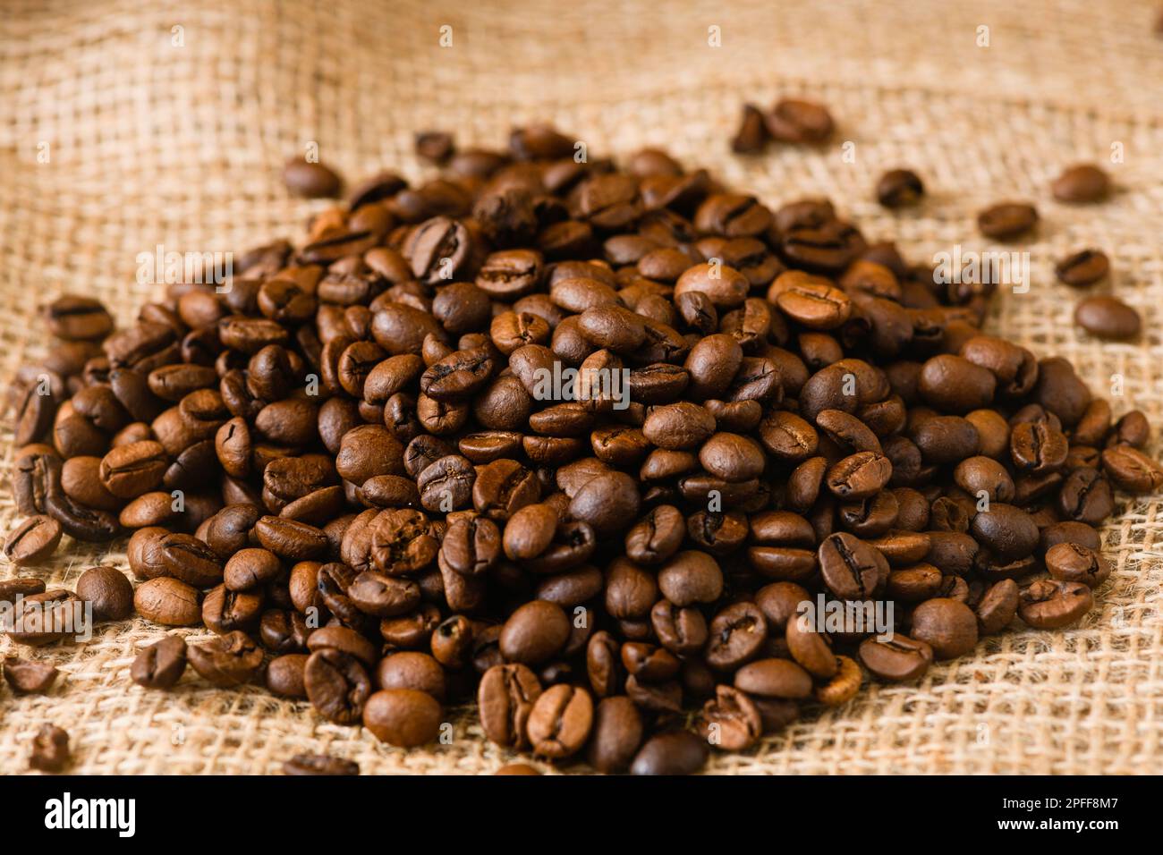 Close up texture of whole roasted coffee beans at sackcloth natural ...