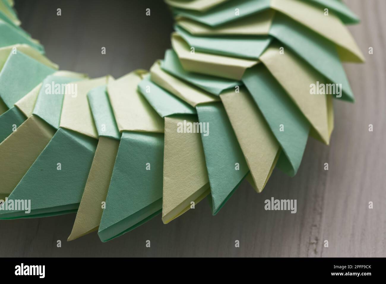 Origami ring, abstract parametric circular structure made of green and ...