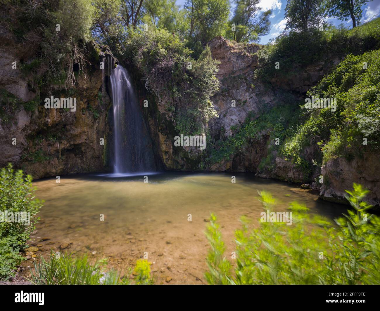 A small waterfall spills into the lake. Clean water sources and natural ...