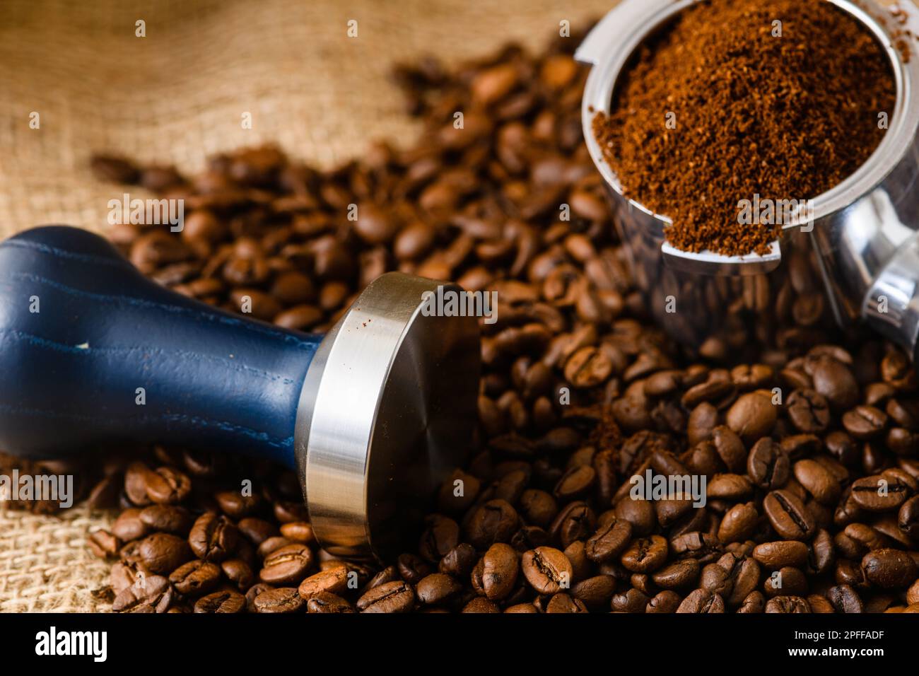 Coffee background with whole roasted beans, carob maker holder and ...
