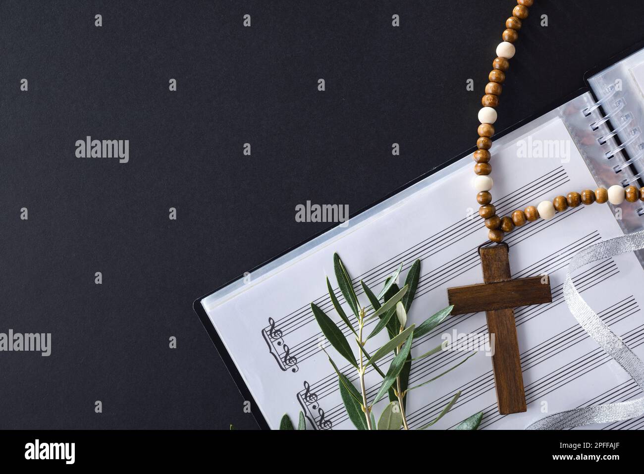 Easter musical background with sheet music in a folder with cross and ...