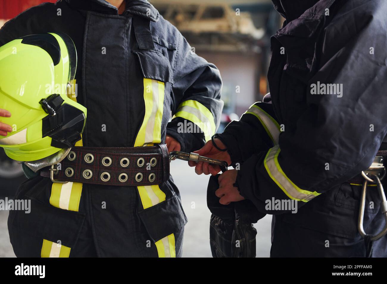 Male and female firefighters in protective uniform standing together ...
