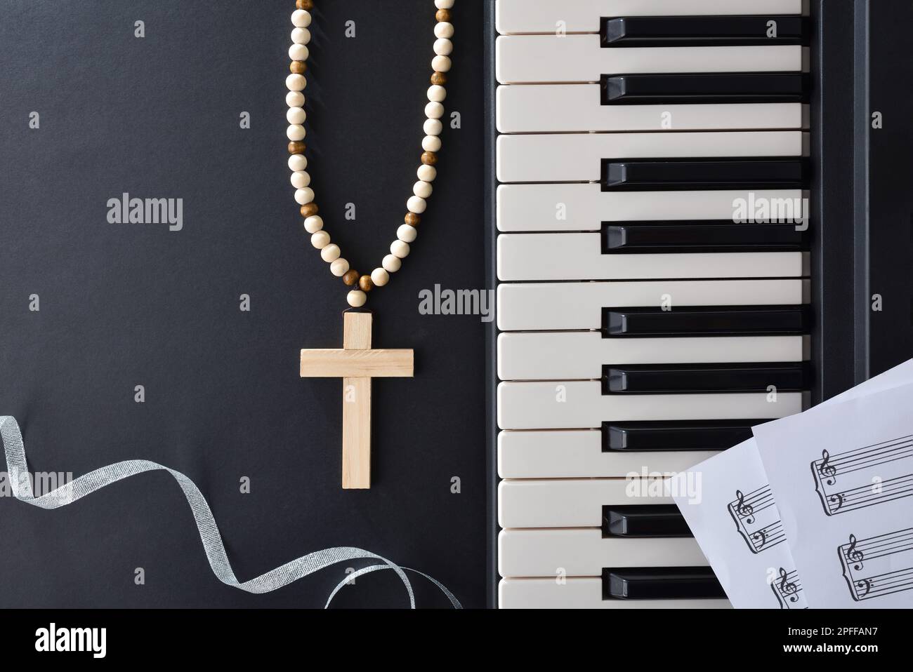 Christian music background with piano and sheet music on black table ...