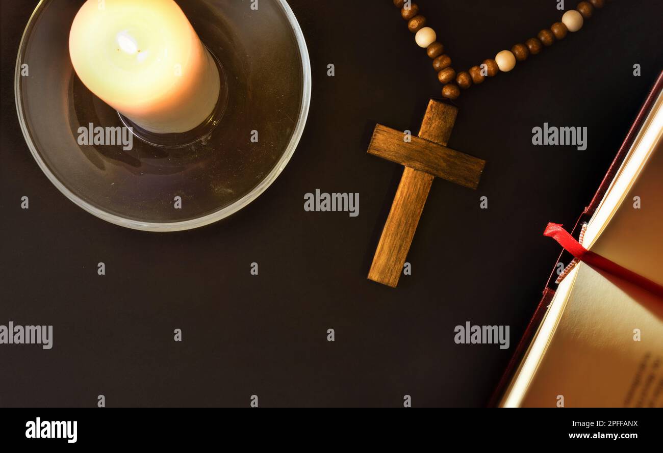 Black bedside table with religious elements to pray with a Christian ...