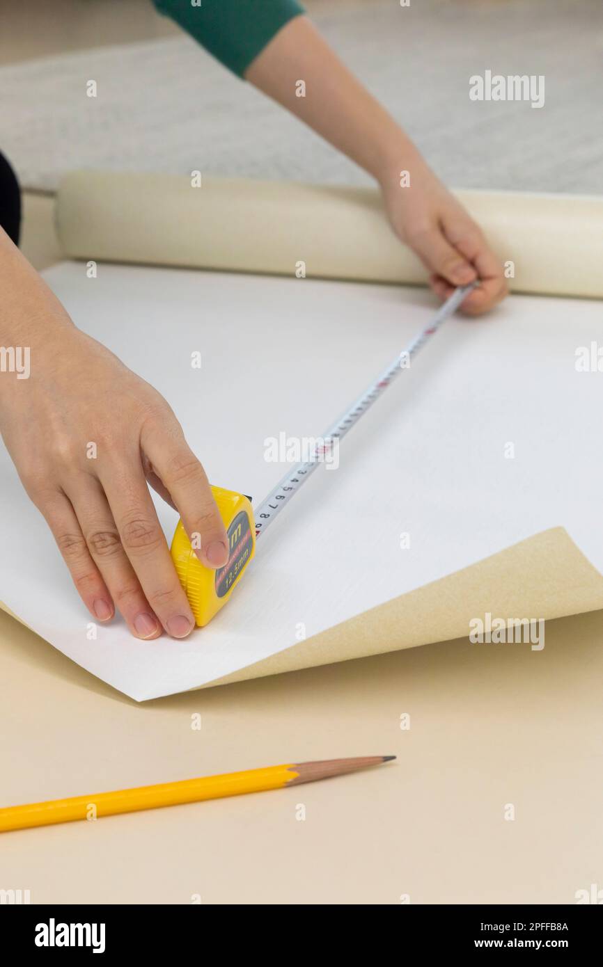 DIY interior hand motion, closeup wallpaper length measurement Stock ...