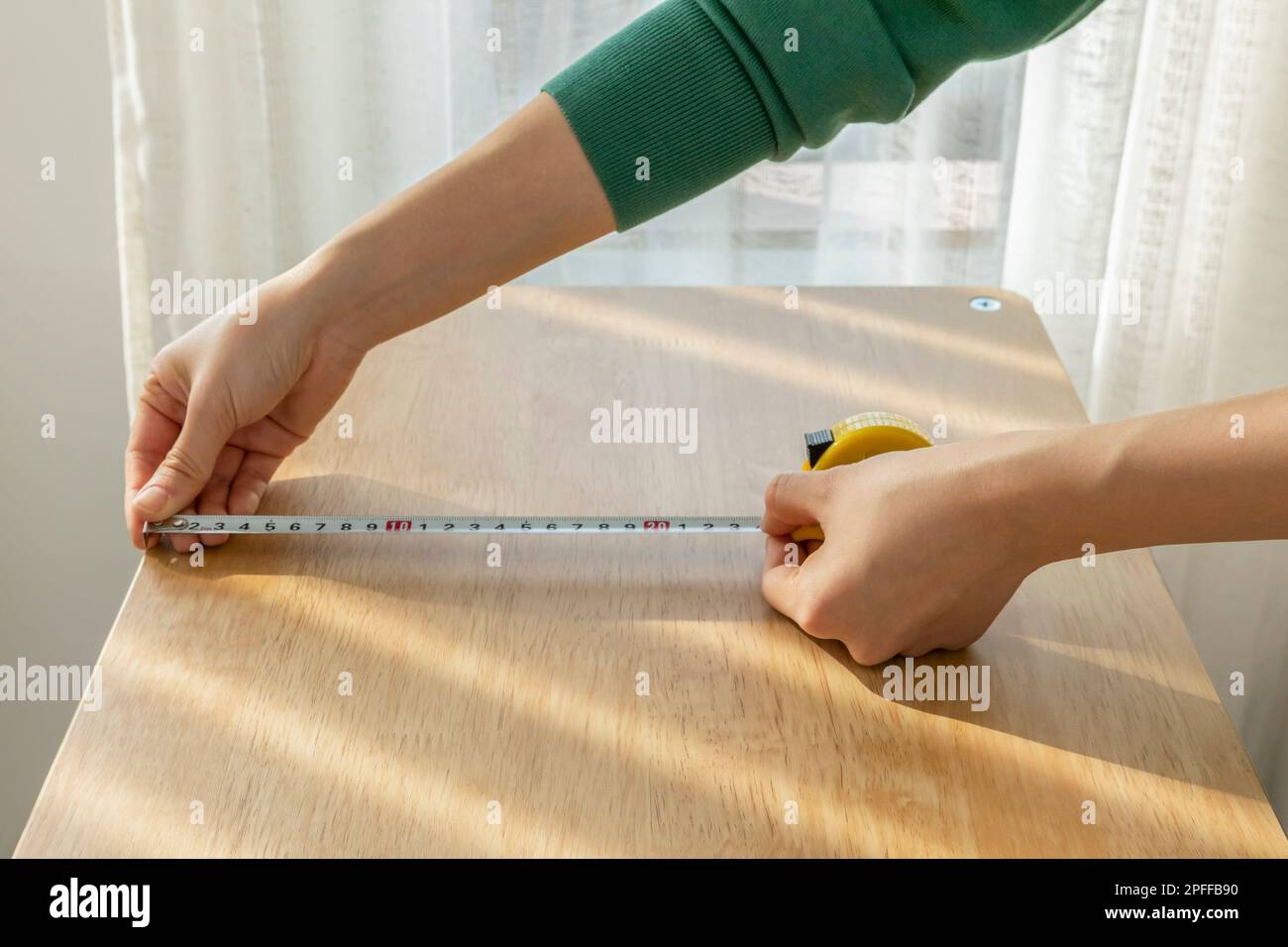 DIY interior hand motion, closeup furniture length measurement Stock ...