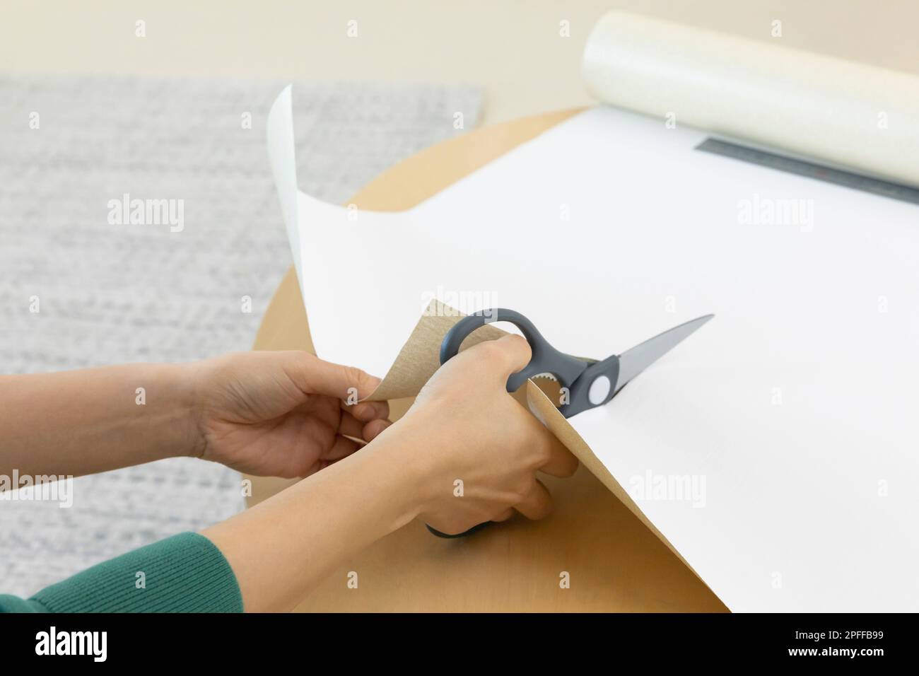 DIY interior hand motion, closeup cut wallpaper Stock Photo - Alamy