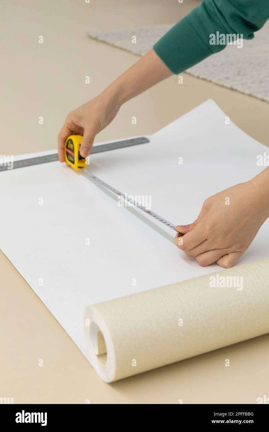 DIY interior hand motion, closeup wallpaper length measurement Stock ...