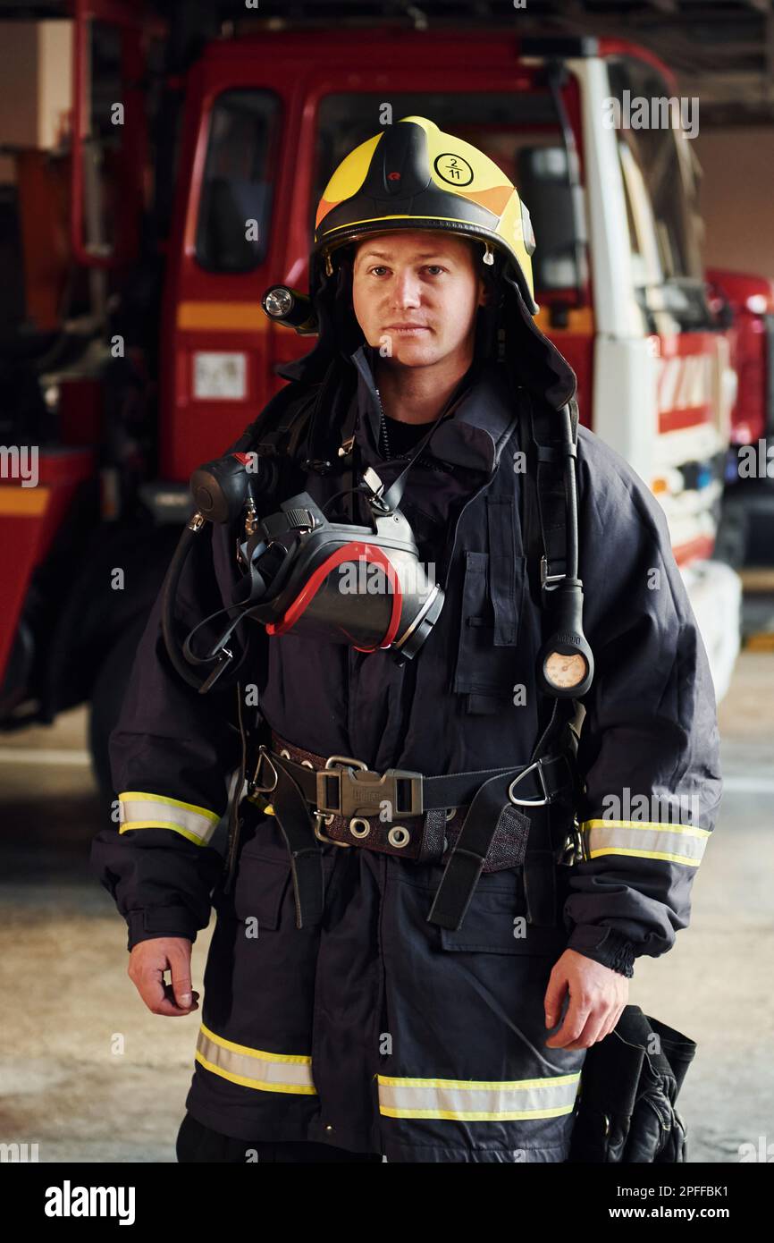 Female firefighter in protective uniform standing near truck Stock ...