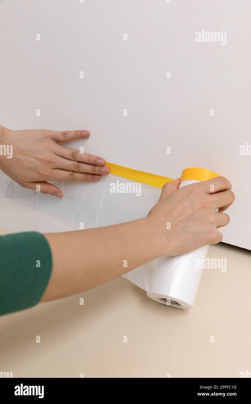 DIY interior hand motion, closeup putting on covering tape Stock Photo ...
