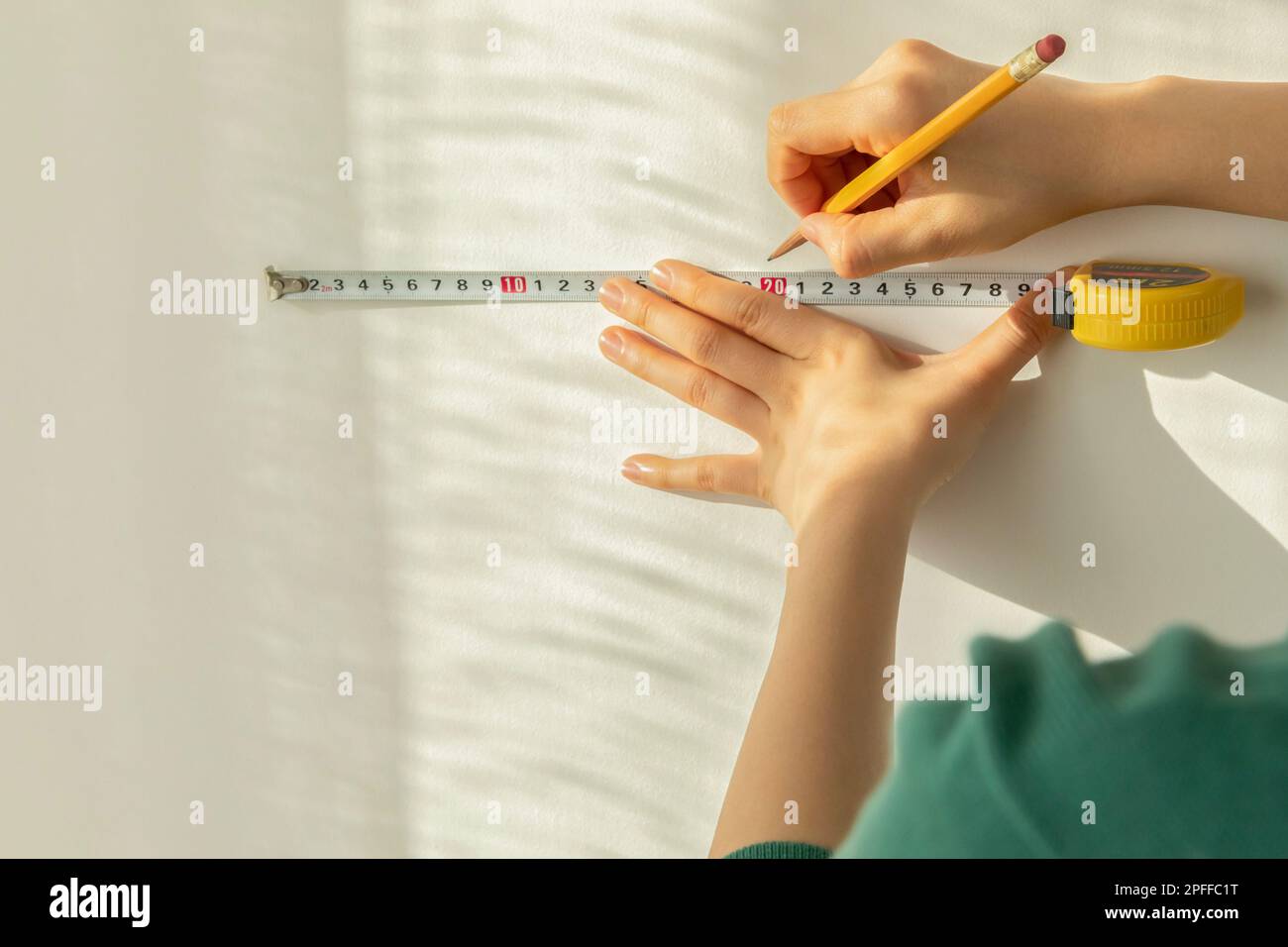 DIY interior hand motion, closeup wallpaper length measurement Stock ...