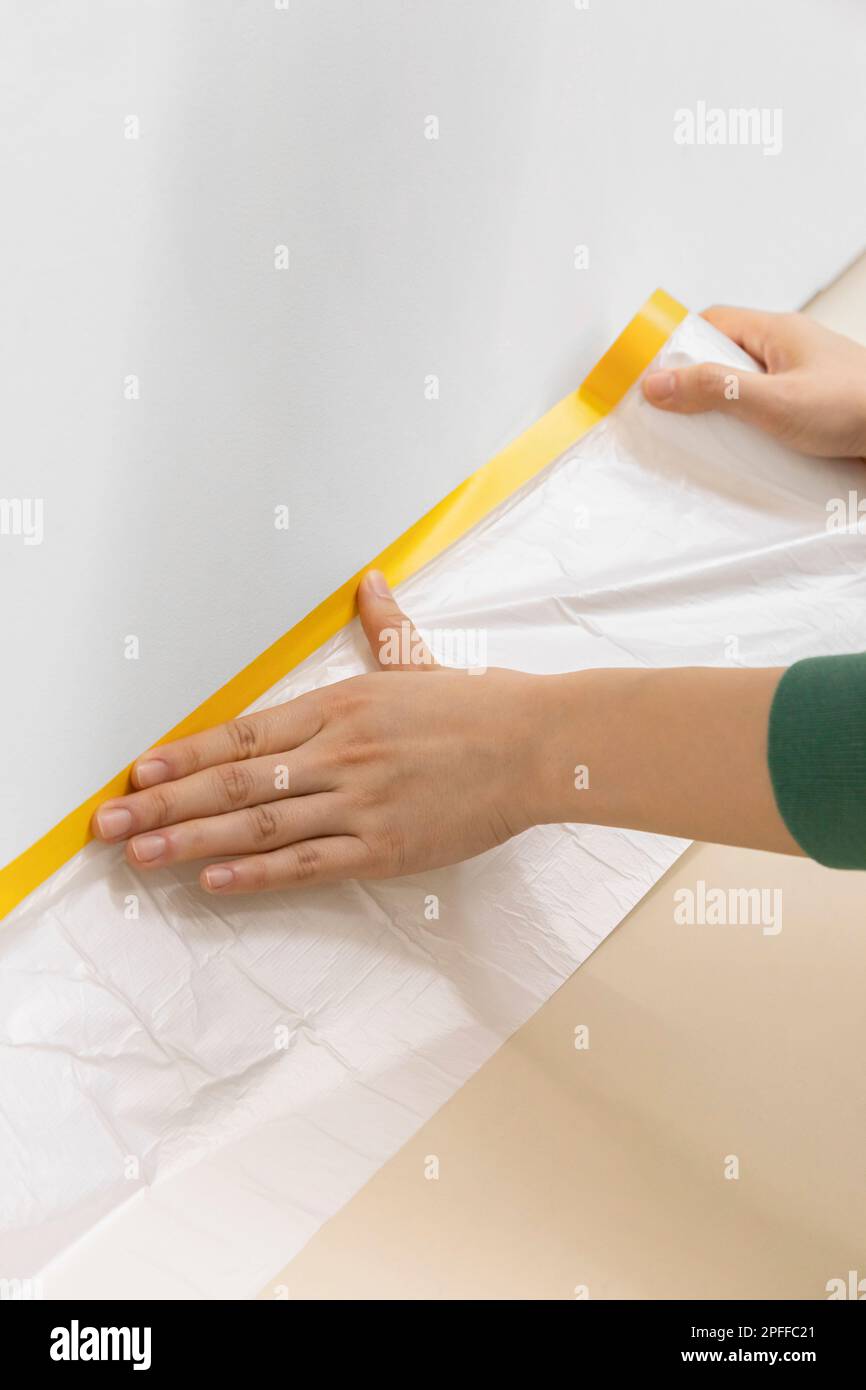 DIY interior hand motion, closeup putting on covering tape Stock Photo ...