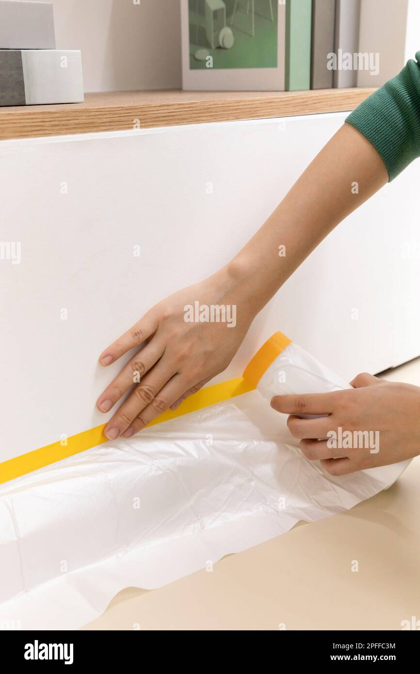 DIY interior hand motion, closeup putting on covering tape Stock Photo ...