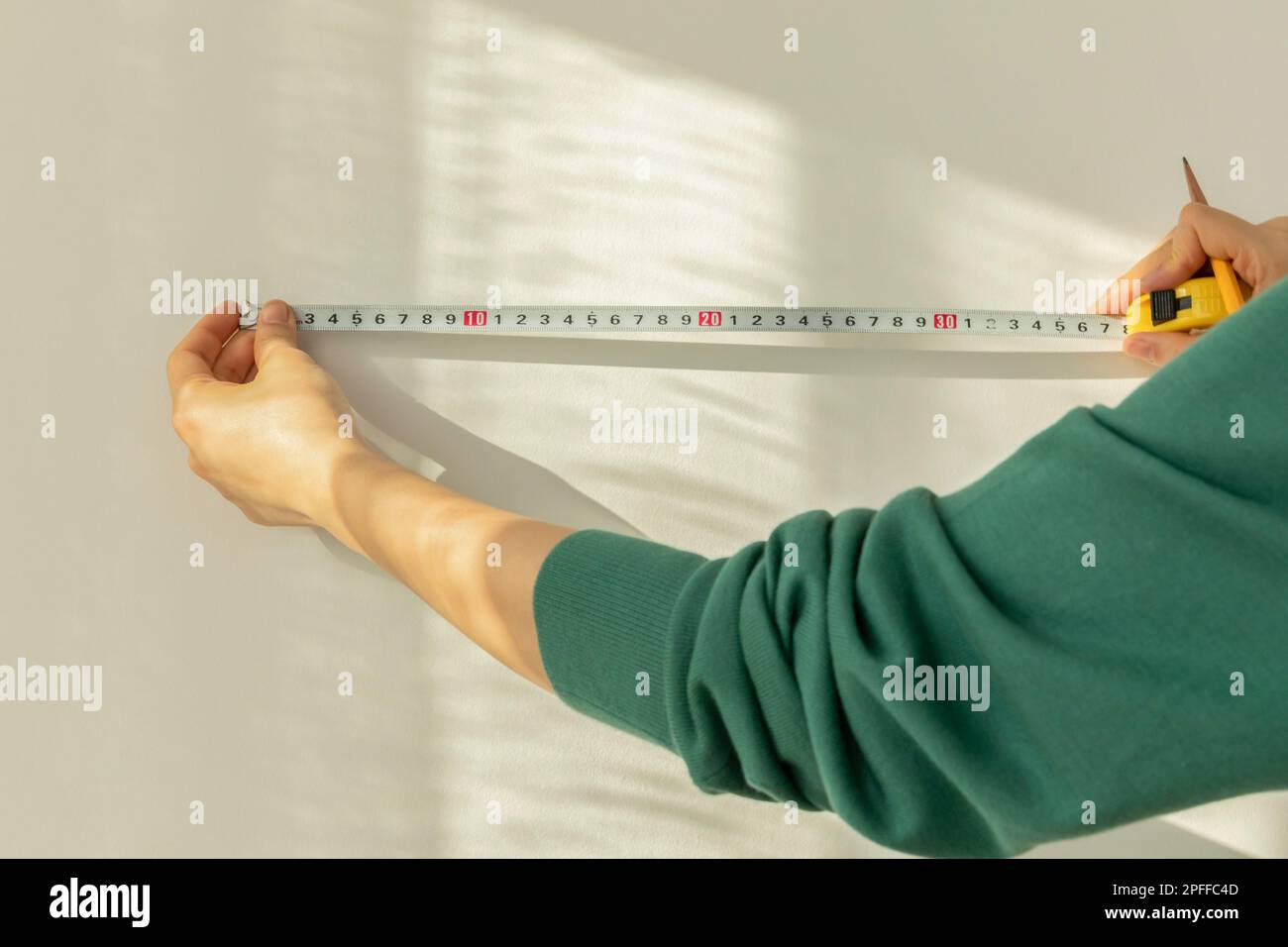 DIY interior hand motion, closeup wallpaper length measurement Stock ...