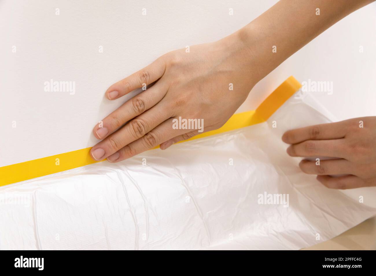 DIY interior hand motion, closeup putting on covering tape Stock Photo ...