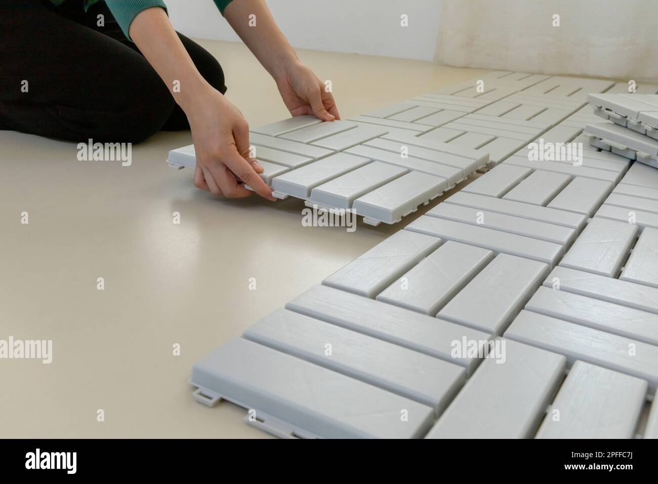DIY interior hand motion, closeup tile a floor Stock Photo - Alamy