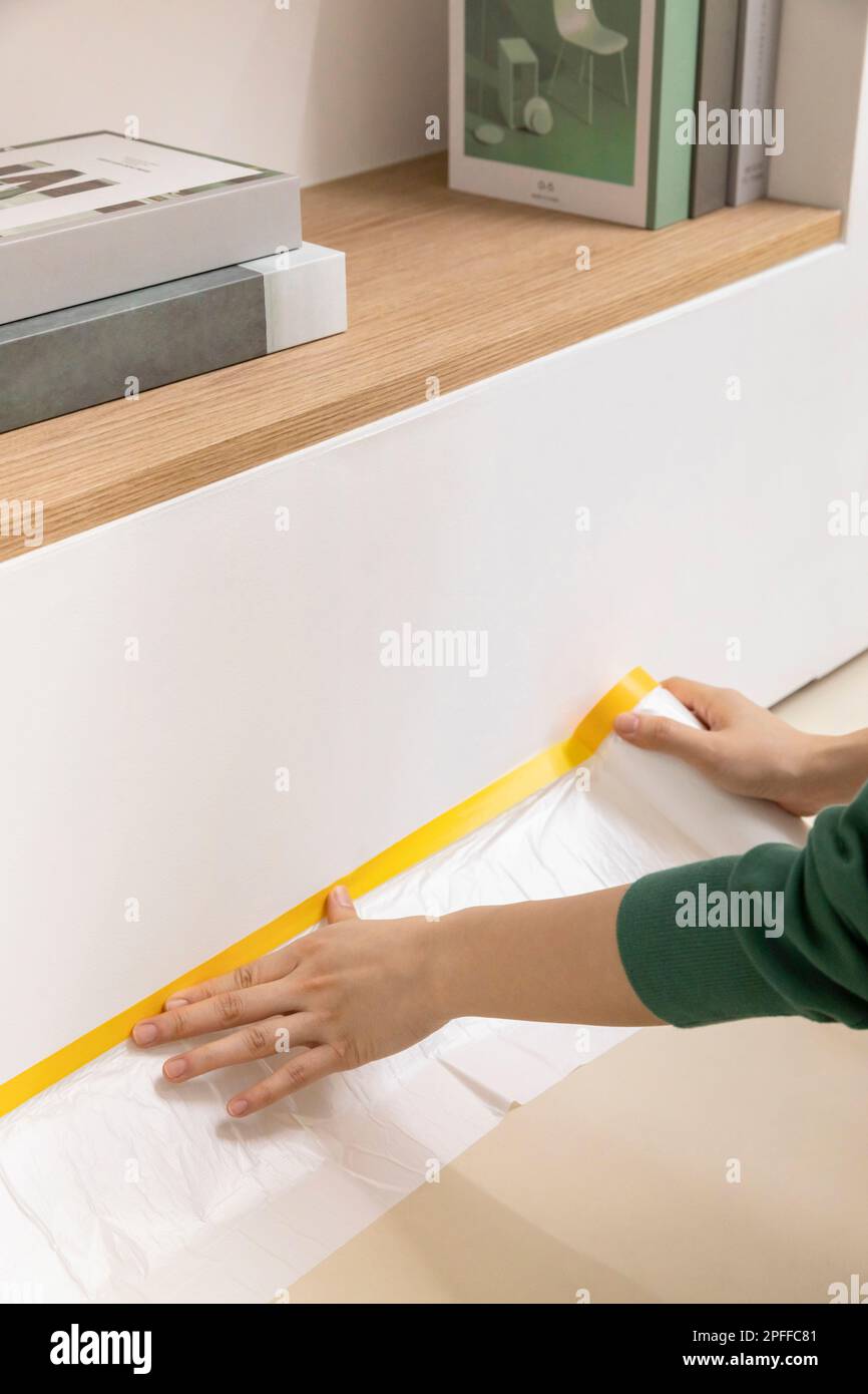 DIY interior hand motion, closeup putting on covering tape Stock Photo ...