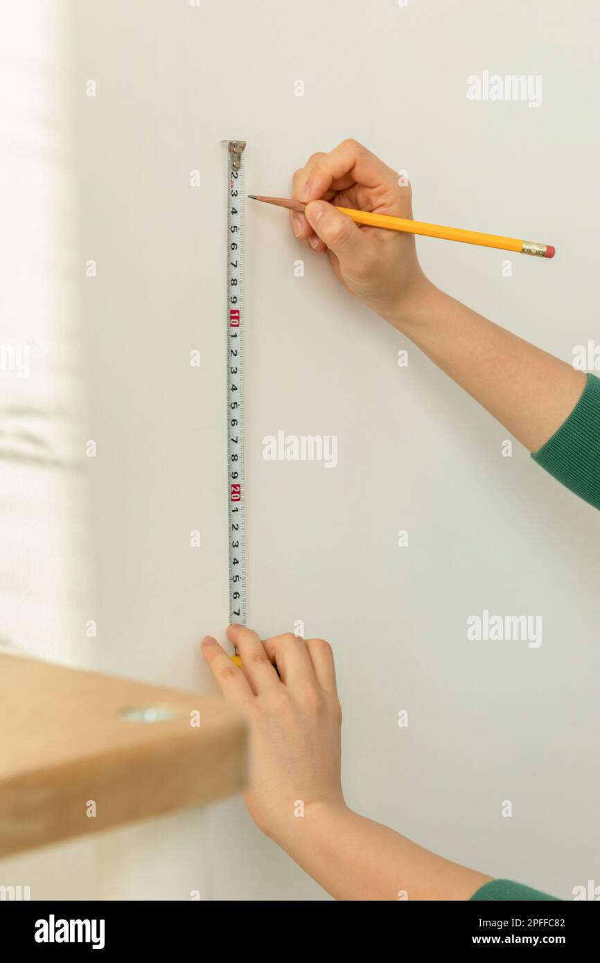 DIY interior hand motion, closeup wallpaper length measurement Stock ...