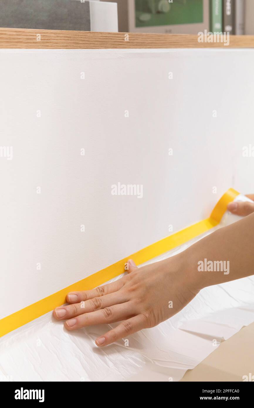 DIY interior hand motion, closeup putting on covering tape Stock Photo ...