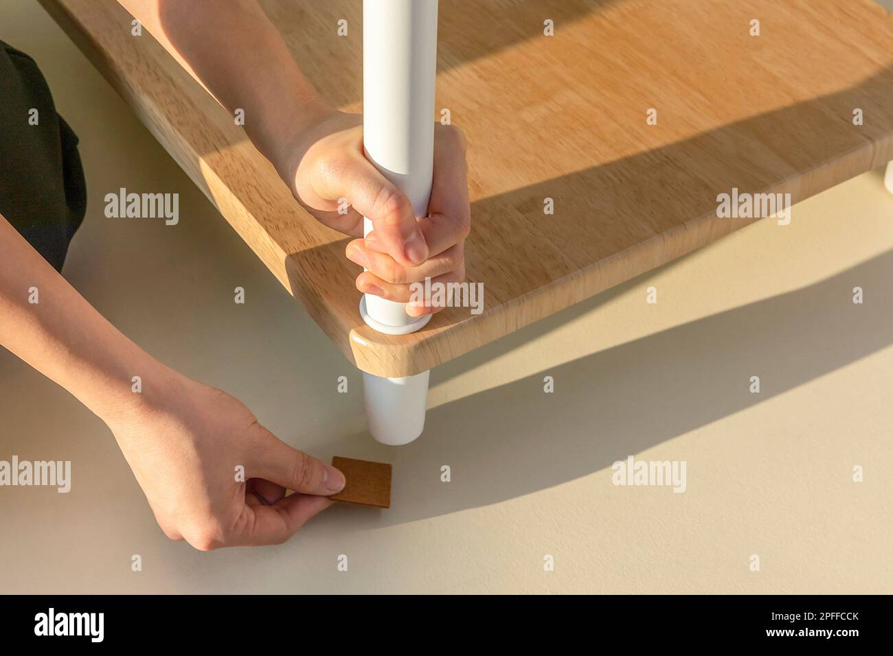 DIY interior hand motion, closeup putting on a floor protection pad ...