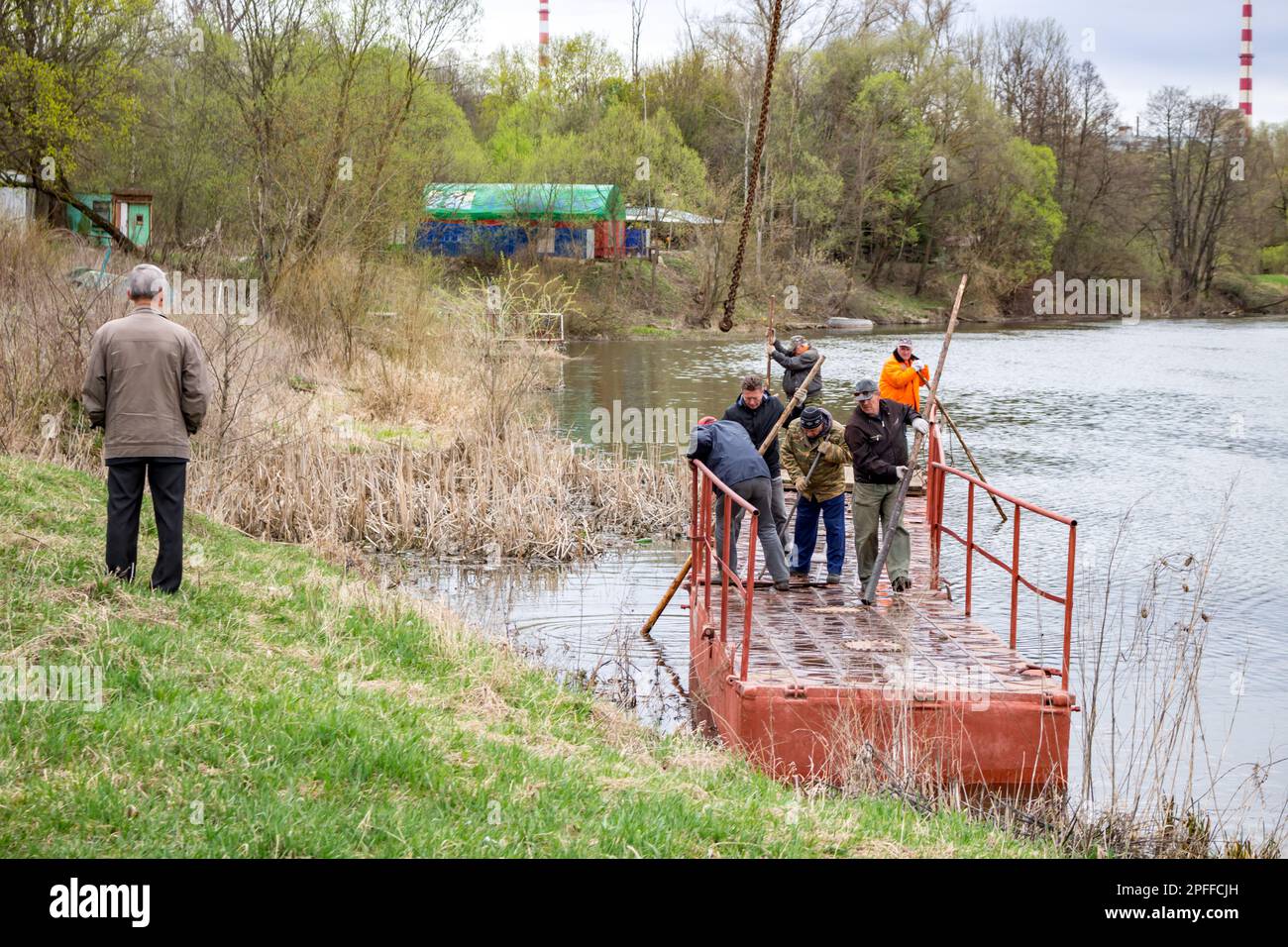 OBNINSK, RUSSIA - APR. 2015: Installation of the pontoon bridge on the ...
