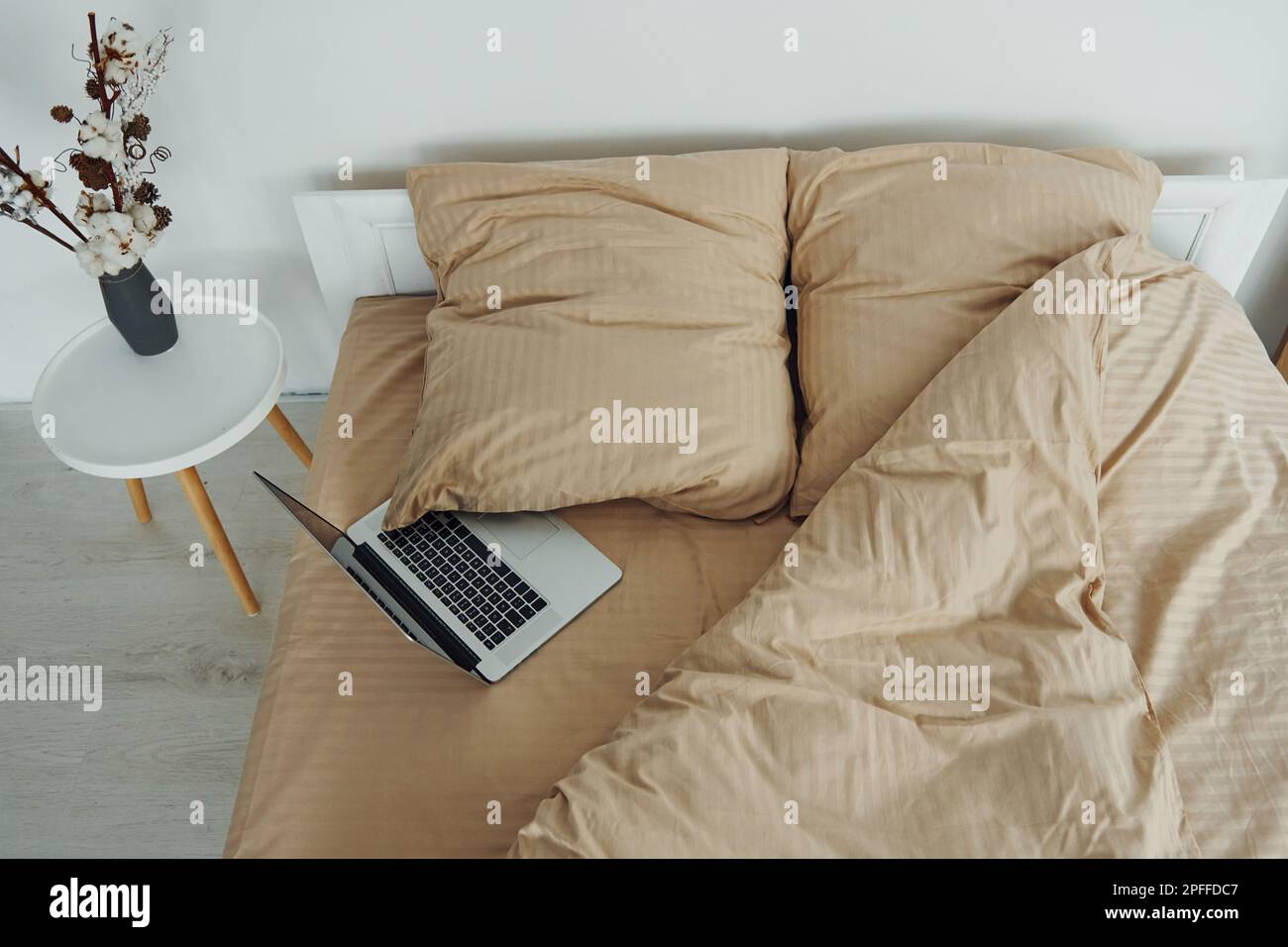 Laptop is on the bed. Interior and design of beautiful modern bedroom ...