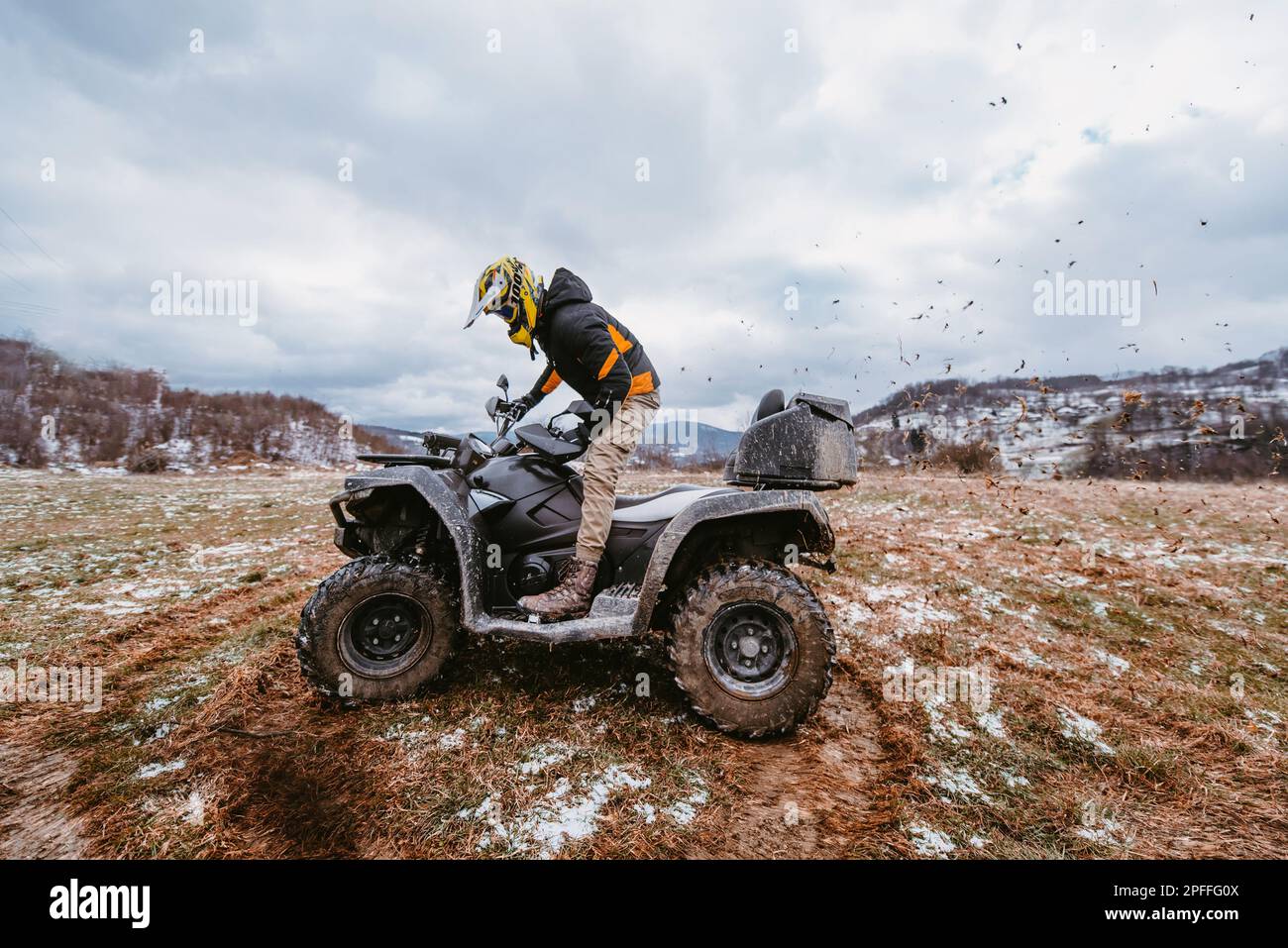 A man drives an ATV in the mud. Drift driving an ATV quad in mud and ...