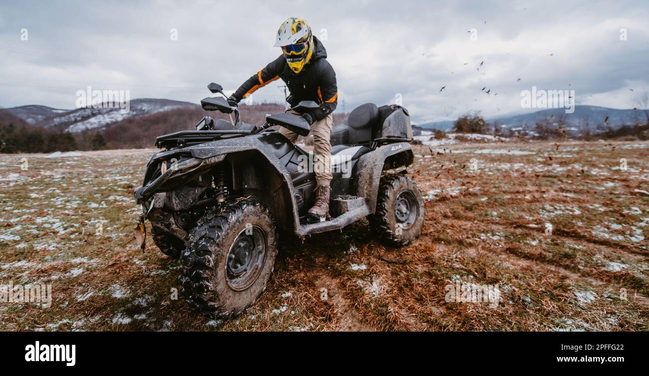 A man drives an ATV in the mud. Drift driving an ATV quad in mud and ...