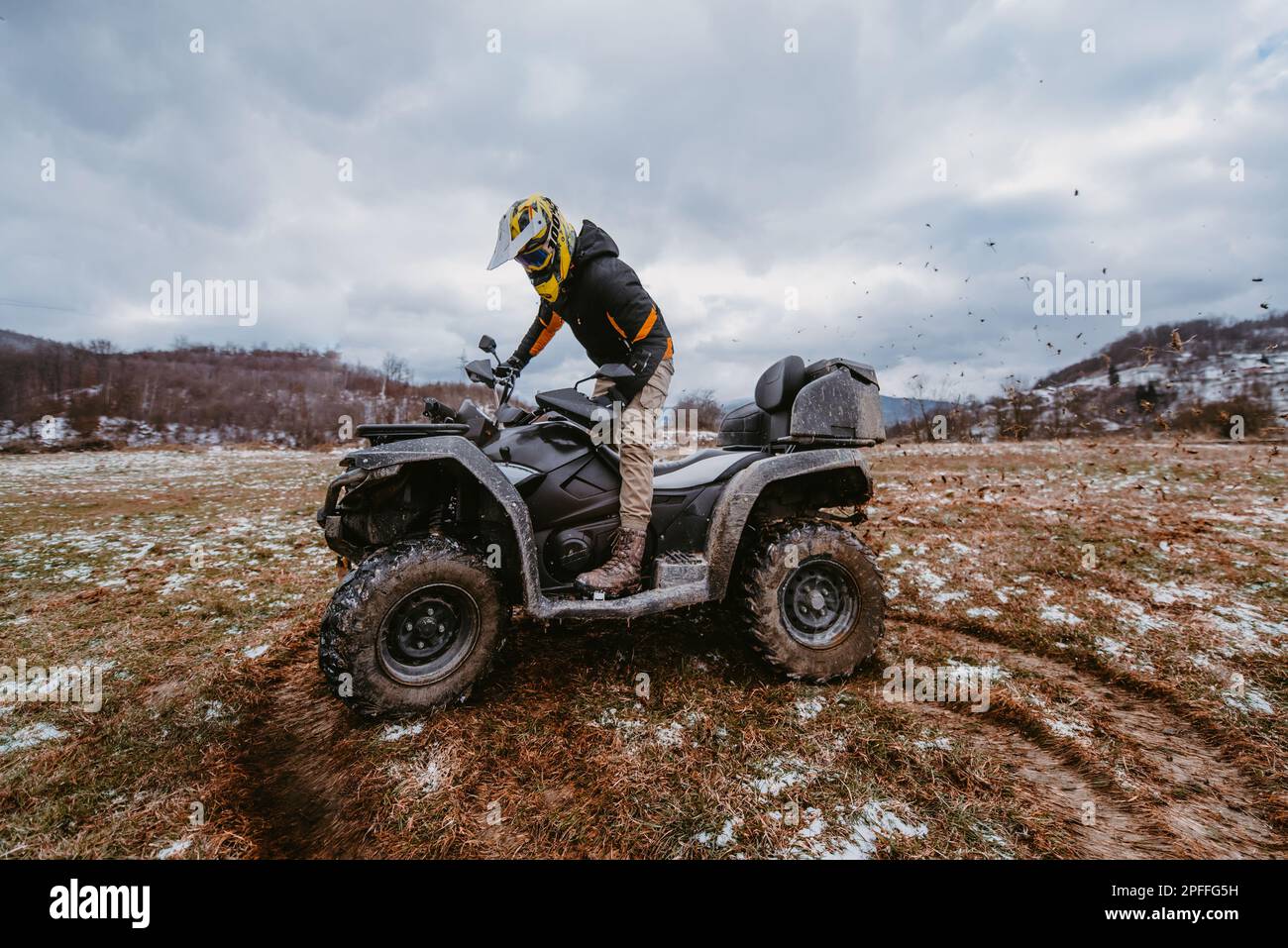A man drives an ATV in the mud. Drift driving an ATV quad in mud and ...