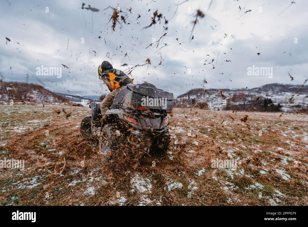 A man drives an ATV in the mud. Drift driving an ATV quad in mud and ...